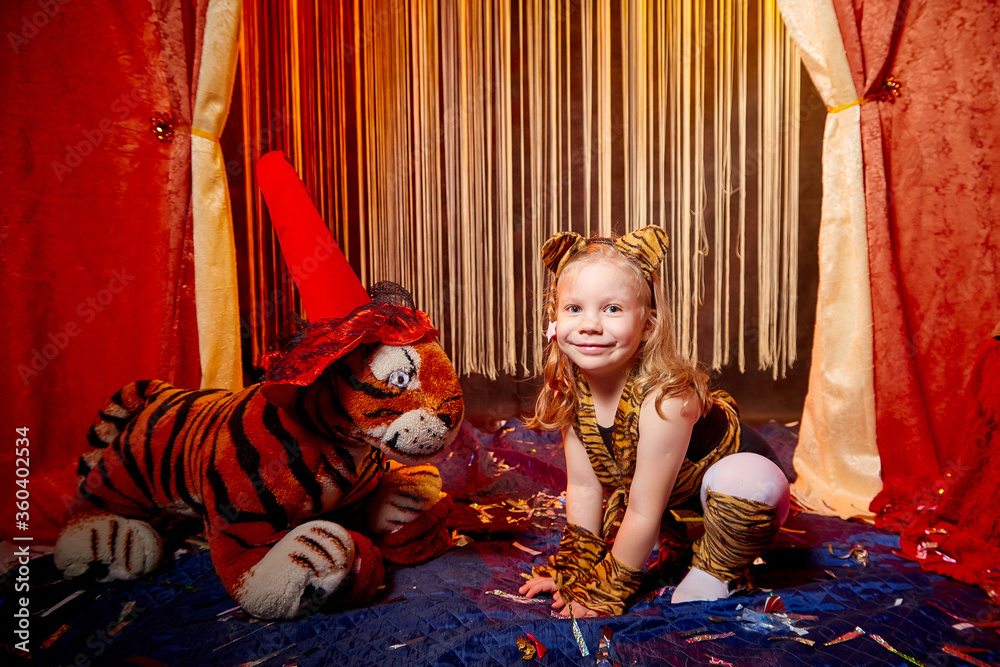 Foto de Stock Little girl dressed in a costume with ears and tail poses ...