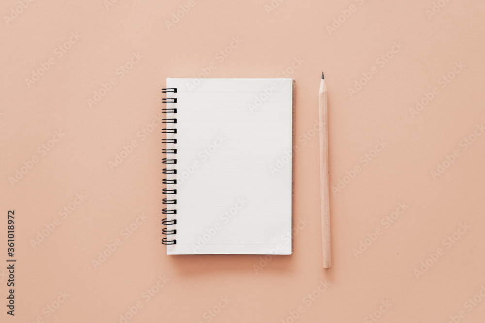Foto de Stock Notebook and pencil on pastel color texture background ...