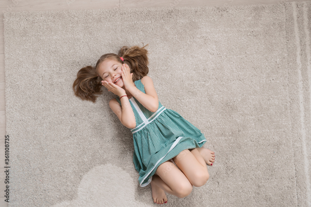 Cute preschool girl making funny faces, playing, having fun while lying ...