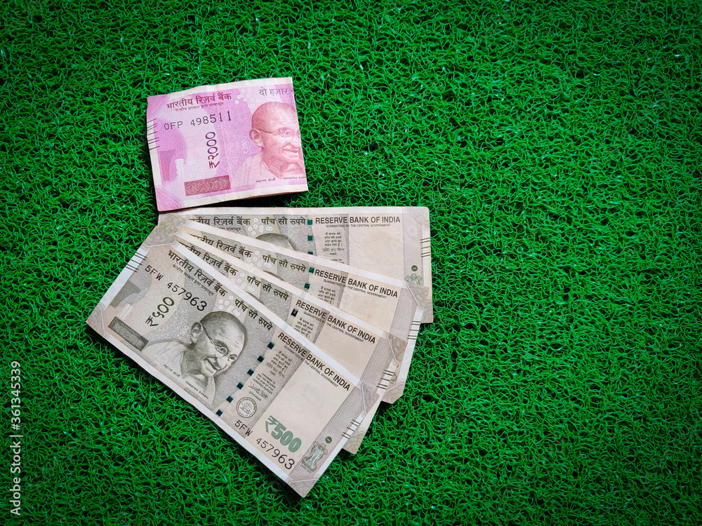 Four 500rs and One 2000rs note isolated on green background. Stock ...