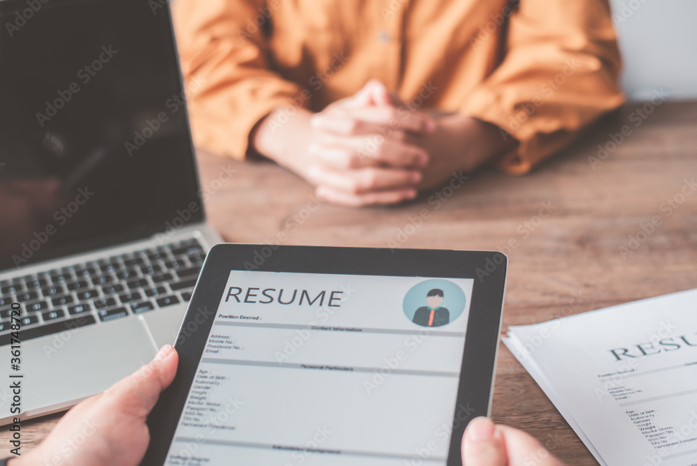 HR managers are interviewing job applicants who fill out their resume ...