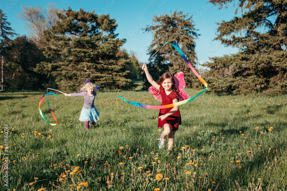 Happy children girls playing with ribbons in park. Cute adorable kids ...