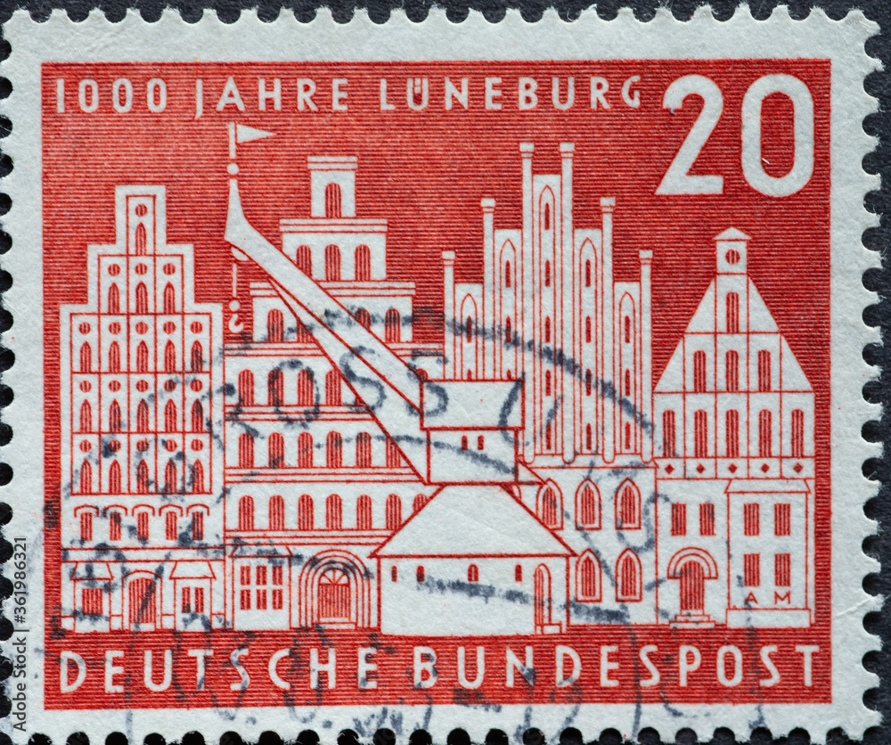 This postage stamp in red shows a historic merchant's house with ...