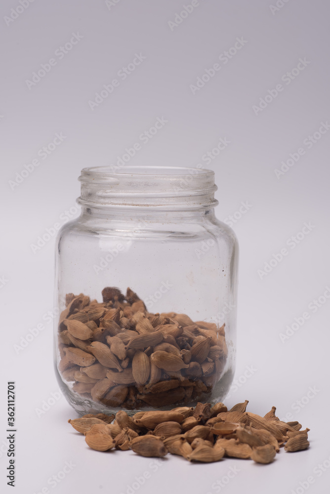 Cardamom inside a see through a jar,over white background Stock Photo ...