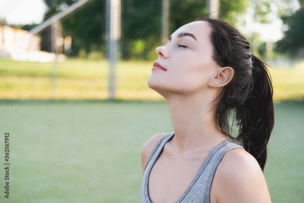 Side view of young beautiful female with closed eyes breathing deeply ...