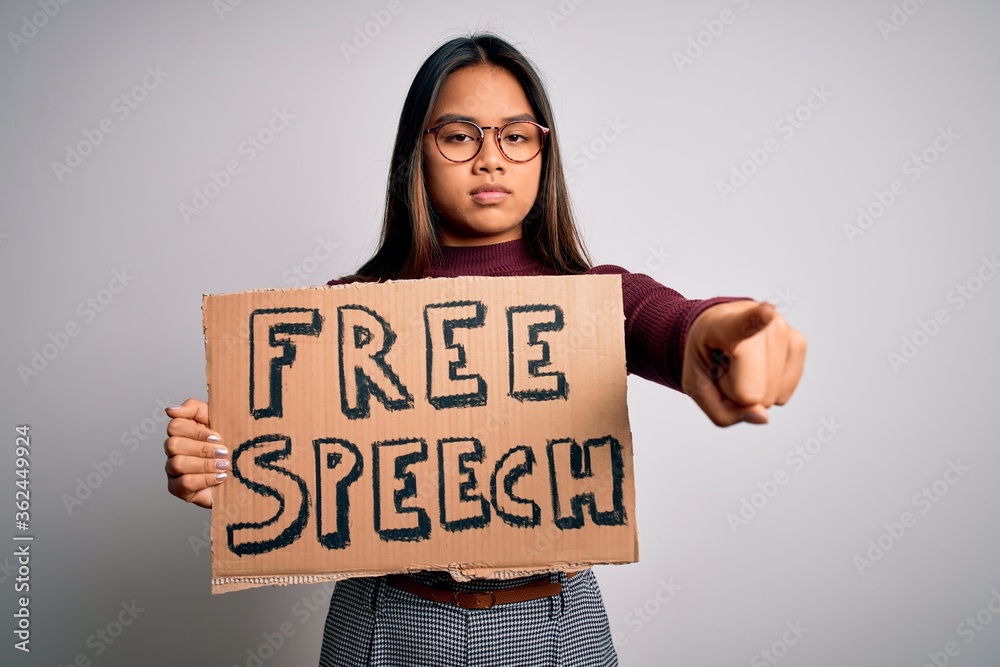 Asian girl asking for rights holding banner with free speech message ...