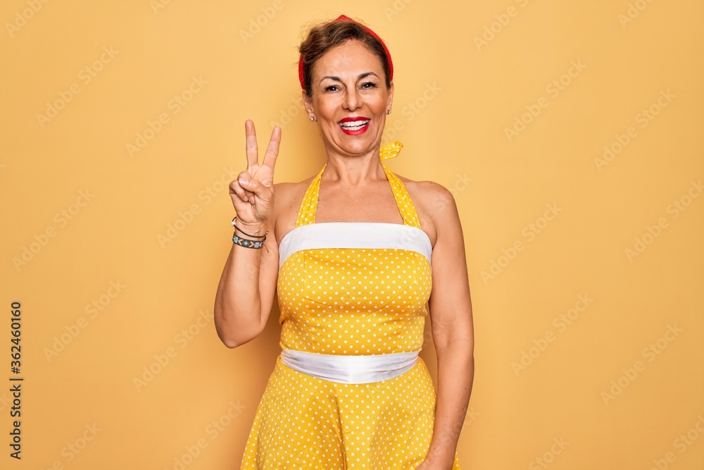 Middle age senior pin up woman wearing 50s style retro dress over ...