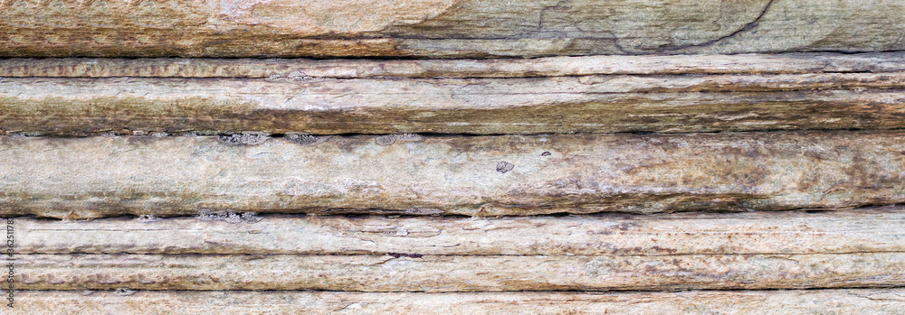 Relief of large gray rock, multi-storey layered rough sedimentary rocks ...