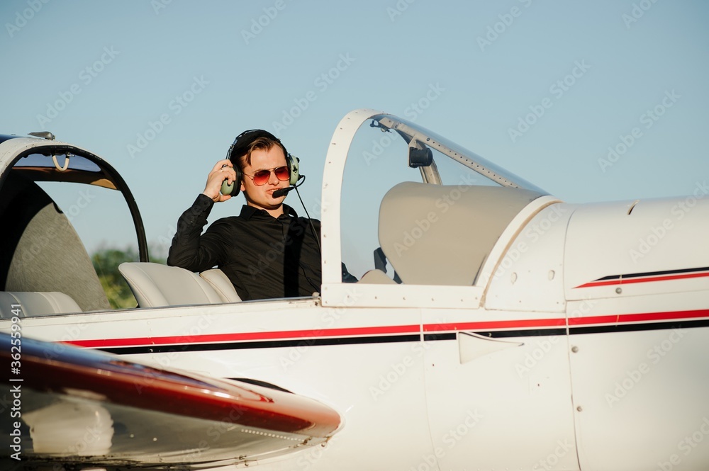 Portrait of confident young man pilot in small plane Stock Photo ...