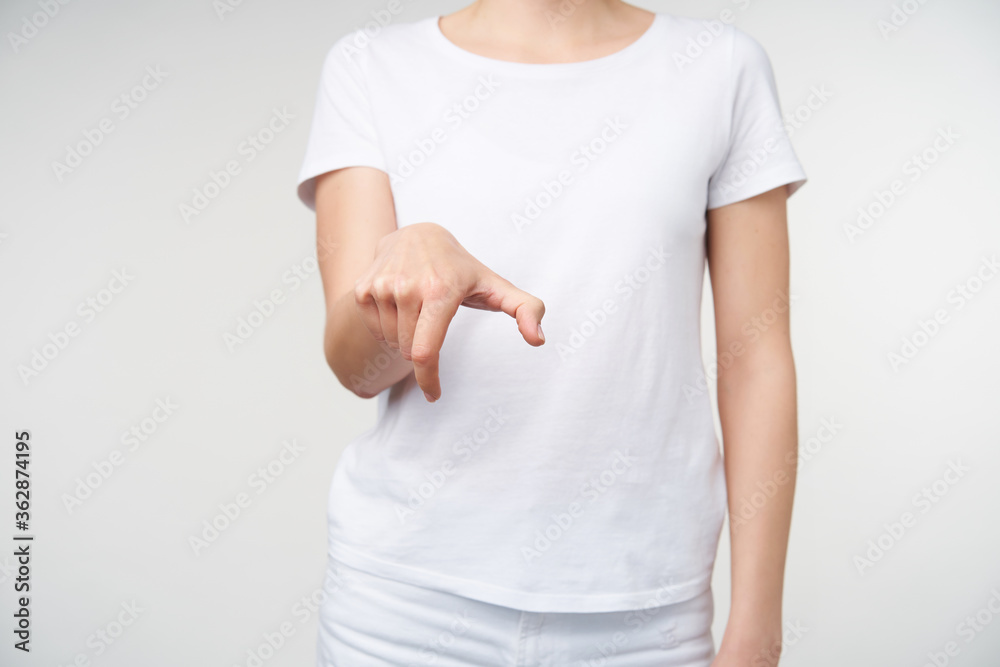 Cropped shot of young female's hand being raised while showing word ...