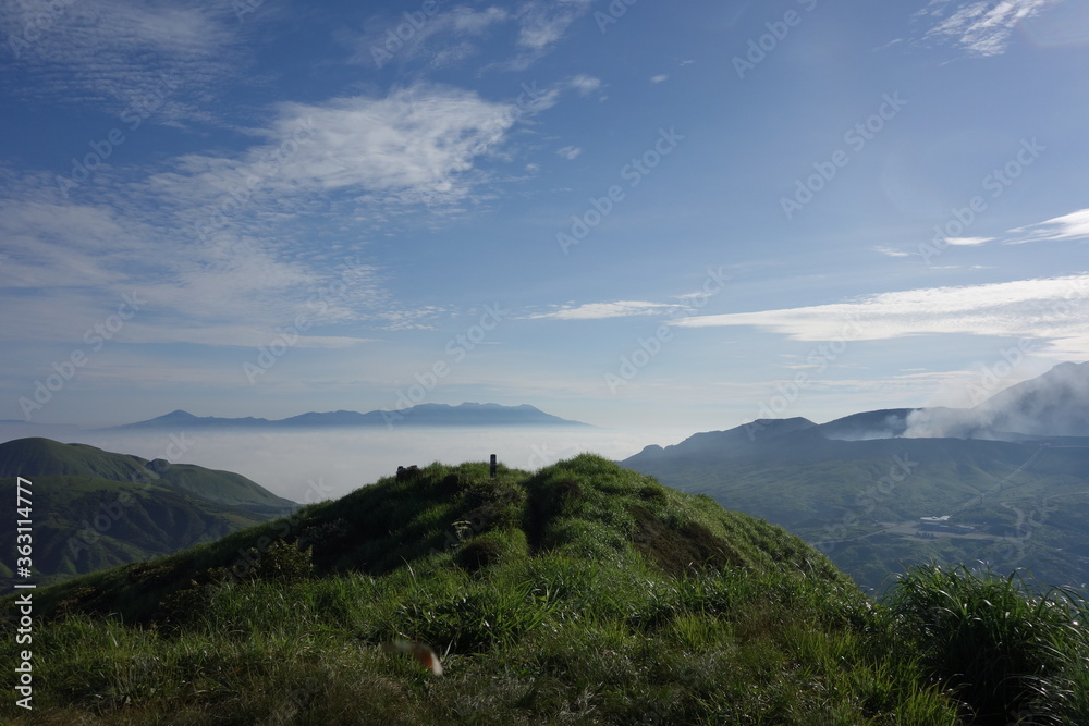 Mt.Kuju range on sea of clouds and small eruption of Mt.Aso from top of ...