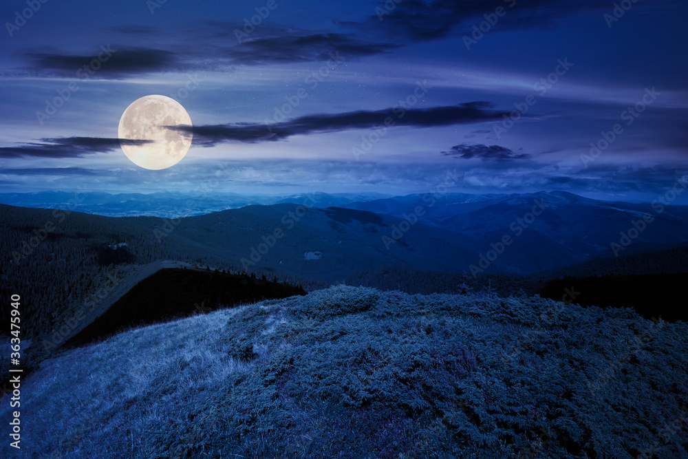 hills and valley of mountain landscape at night. clouds on the deep ...