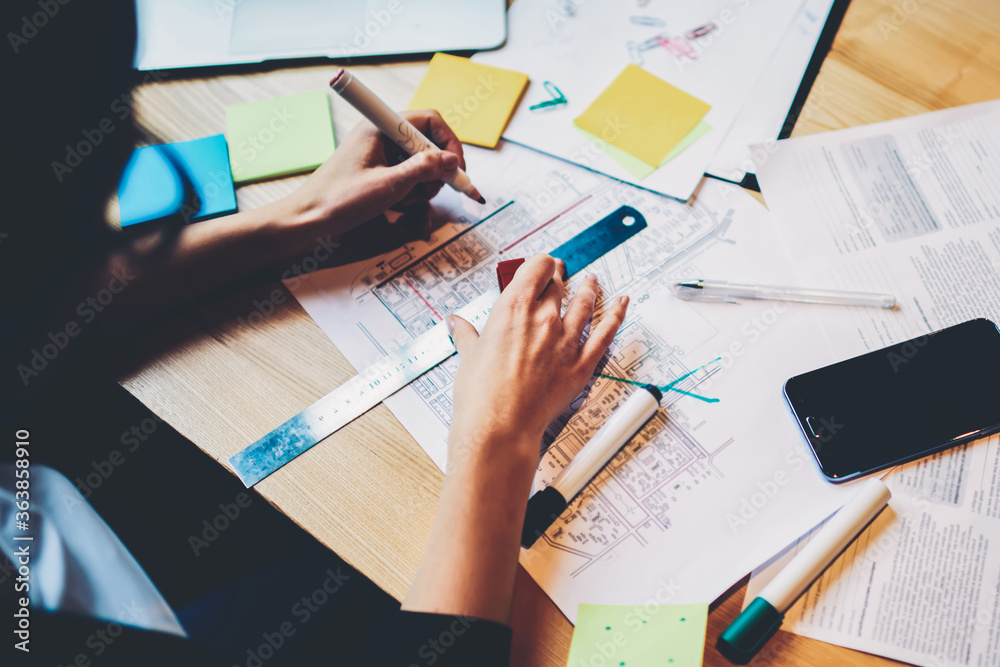 Cropped image of architect with red marker and line drawing lines on ...