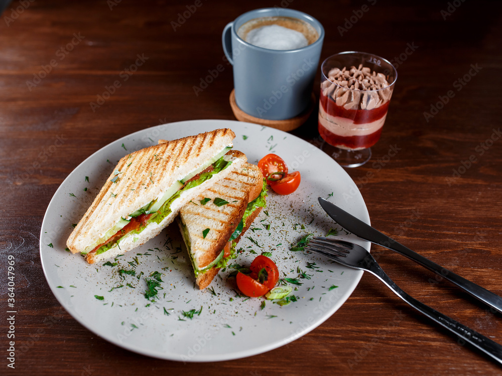 Toasted shredded chicken breast and salad sandwich served on a rustic ...