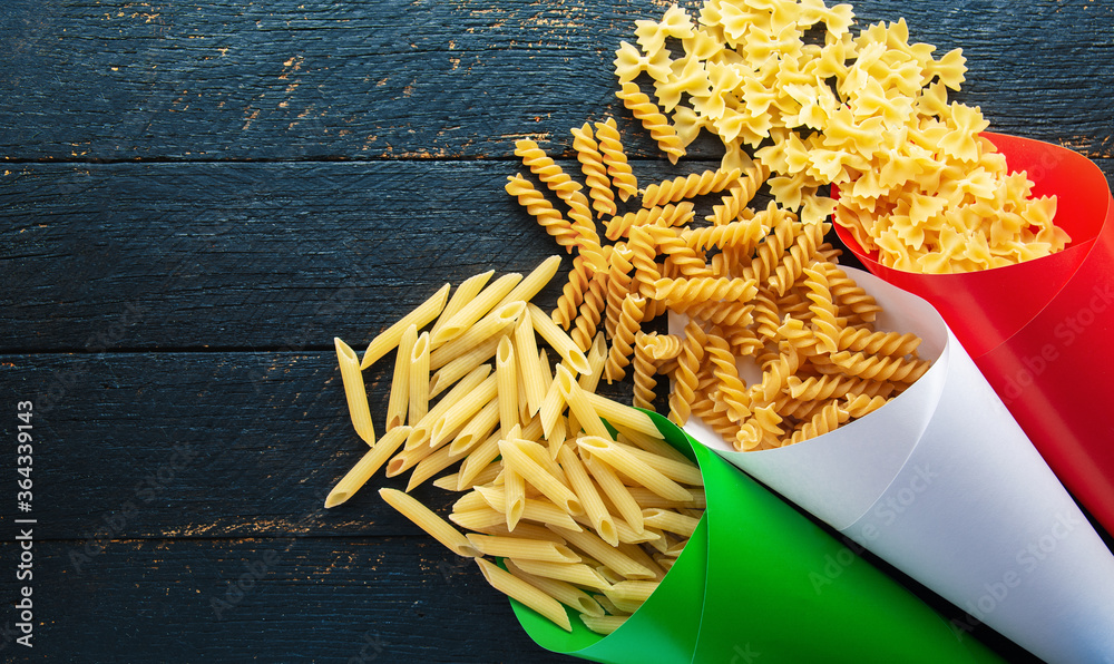Variety types and shapes of raw Italian pasta in paper of Italy flag ...