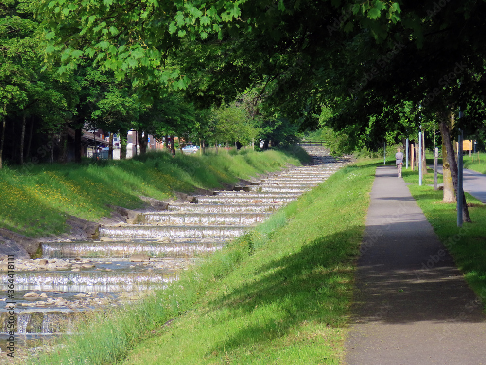 A promenade with an alley along the artificial cascades of the Kleine ...