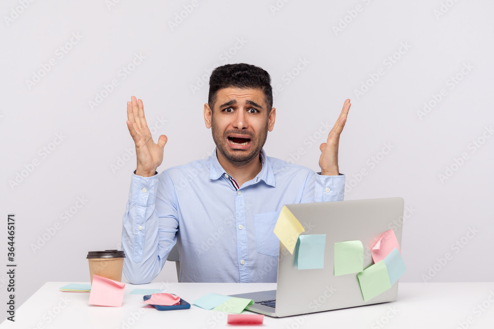 Overtime, overwork concept. Shocked scared man employee sitting in ...