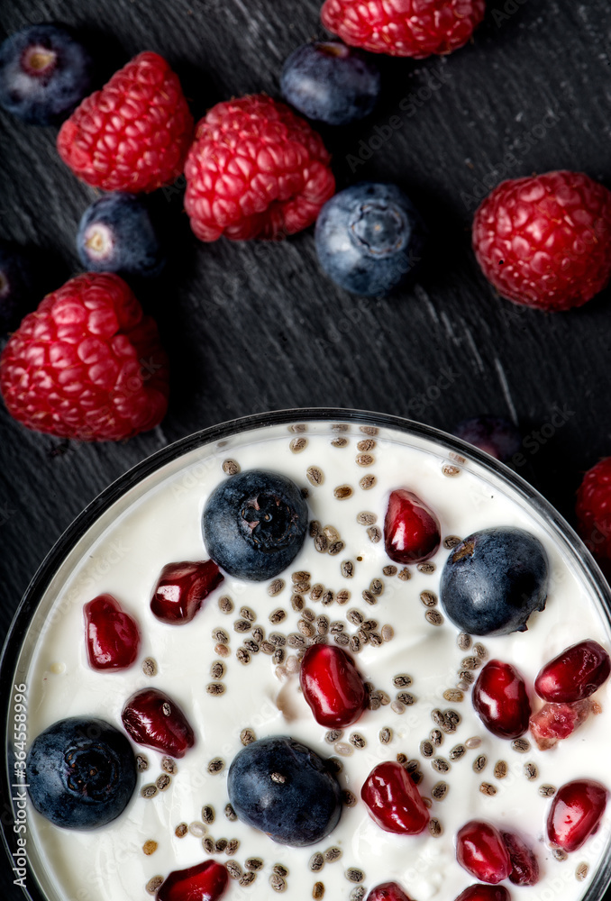Top view of round bowl with fresh dairy yogurt topped with pomegranate ...