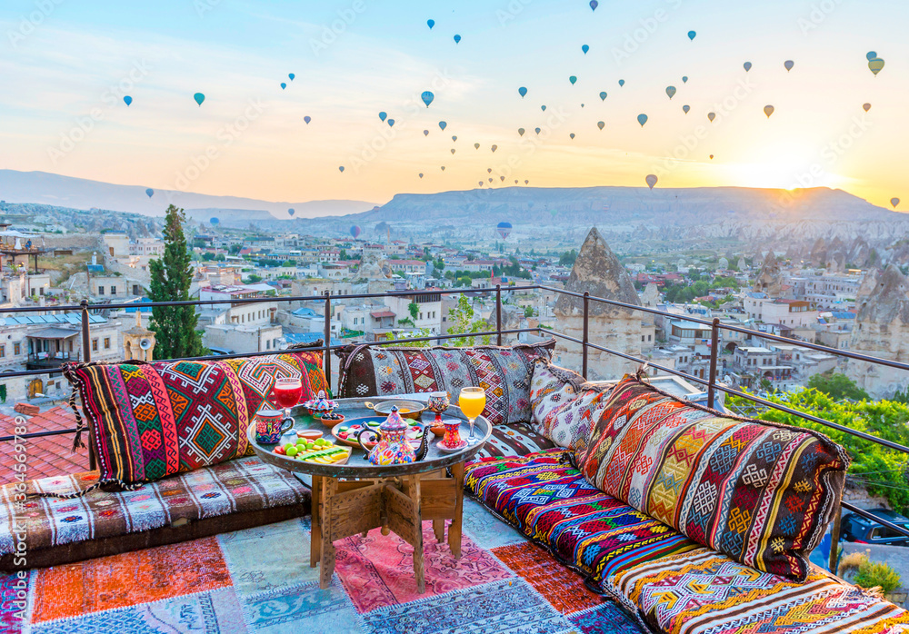 Traditional turkish breakfast with Cappadocia view and flying balloons ...