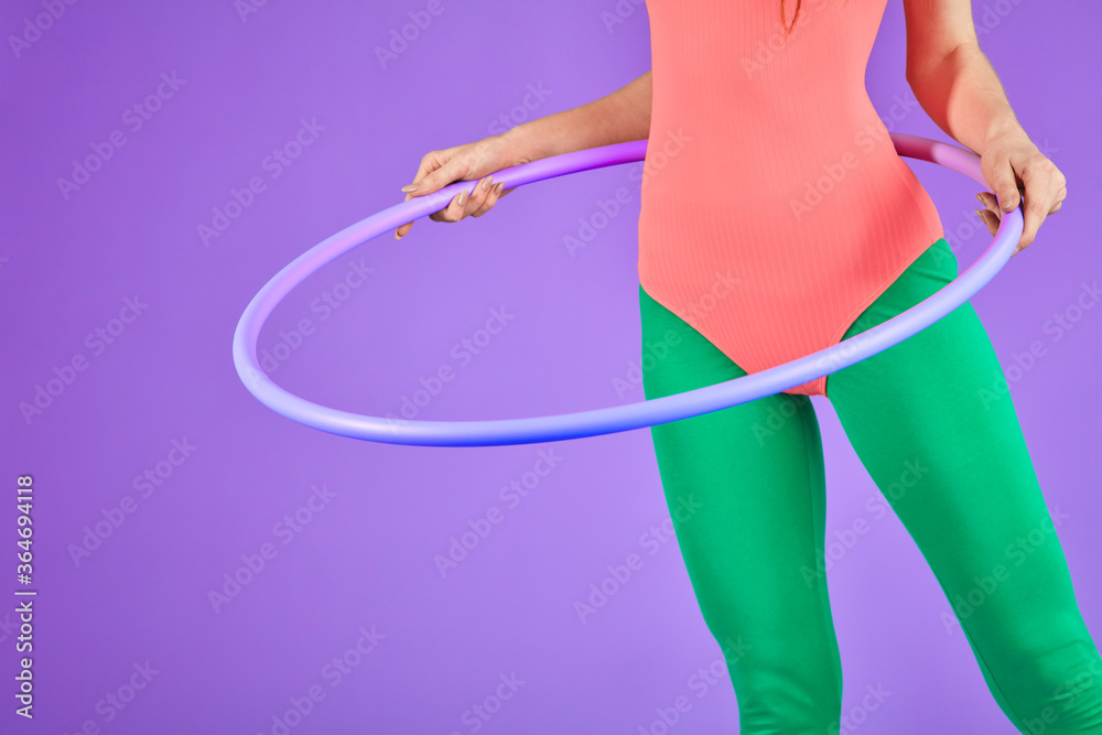 half view of unrecognizable fitness woman standing and holding hula ...