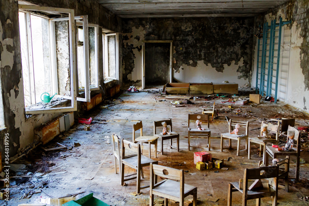 Broken doll in Chernobyl and Pripyat school and kindergarten. Left ...