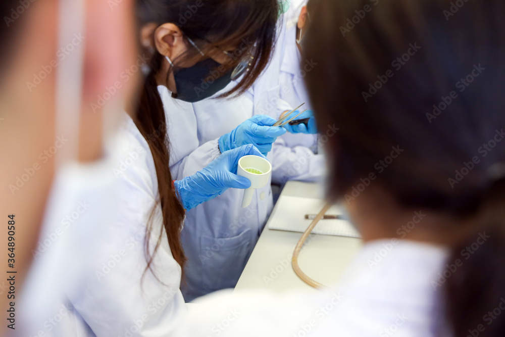 Scientist analysis the total solids experiment by using filter paper ...