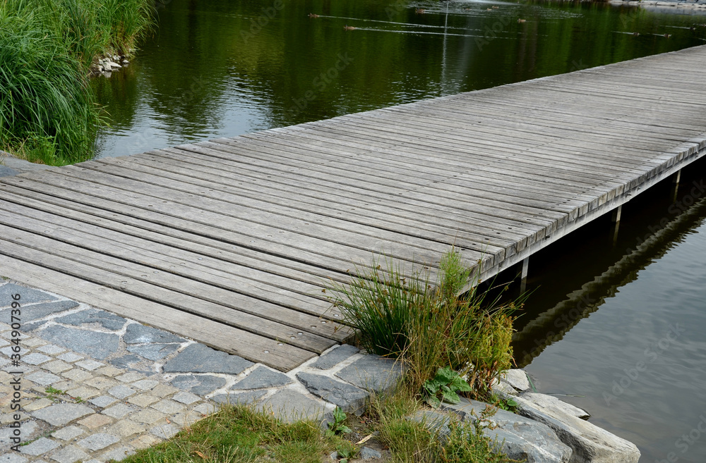 wooden wide pedestrian bridge over the river pond lake, without ...