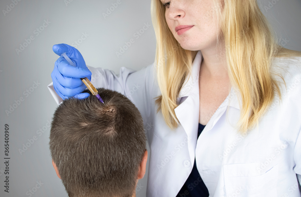 Stock-Foto „The doctor trichologist conducts mesotherapy or plasma ...
