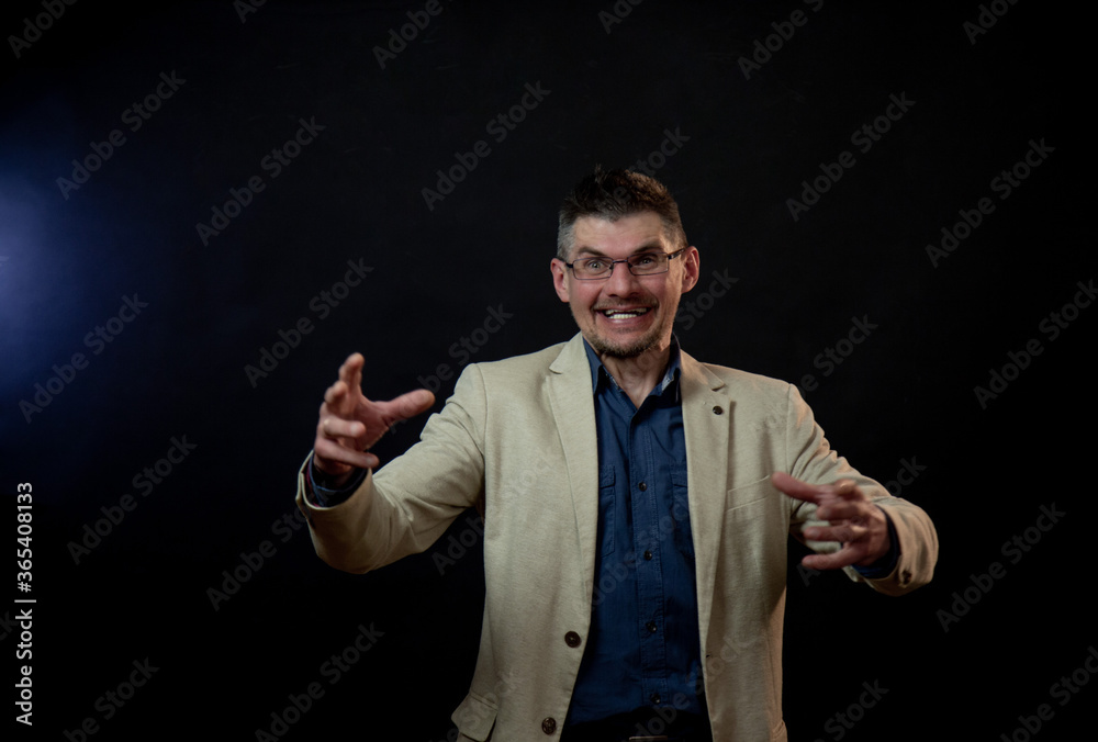 professional actor plays role of delighted man standing on black studio ...