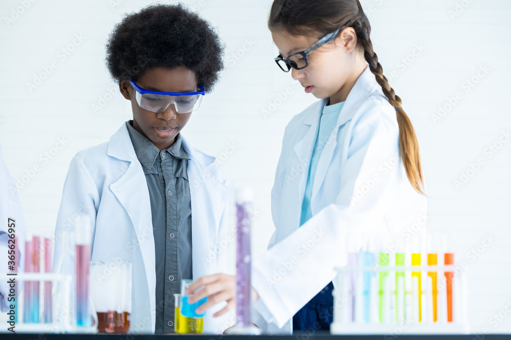 Kid in lab coat learning chemistry in school laboratory, Kid scientist ...