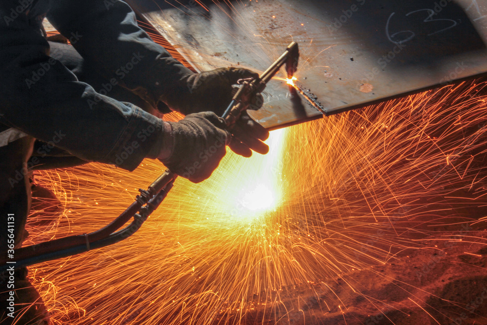 Stock Foto Cutting metal plate with oxygen. Oxy fuel welding commonly called oxyacetylene welding oxy welding or gas welding in the United States and oxy fuel cutting are processes. Adobe Stock