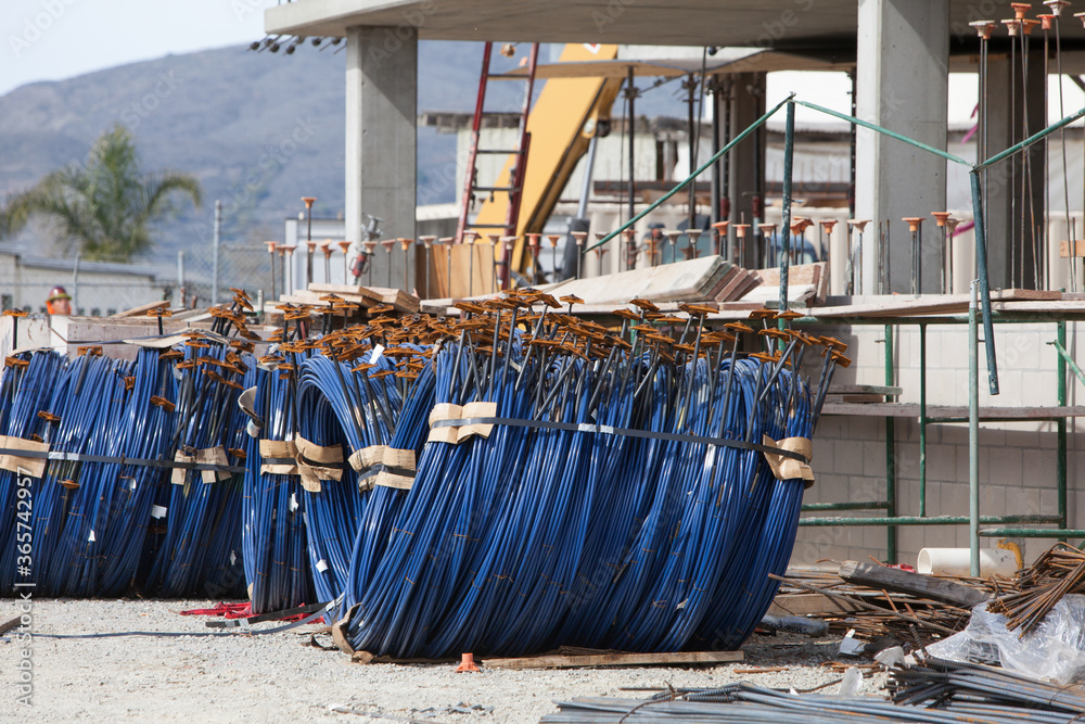 large rounds of blue tubing stacked together at construction site used ...