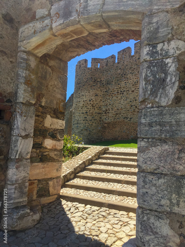 Battlement, turret, and loopholes of medieval castle seen through door ...