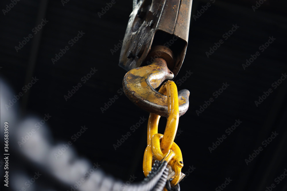 Stock-Foto „Crane hook on which chains with hooks are attached. Lifting ...