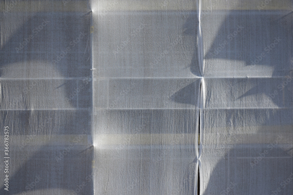 Dust protection net installed on the scaffolding of a building under ...