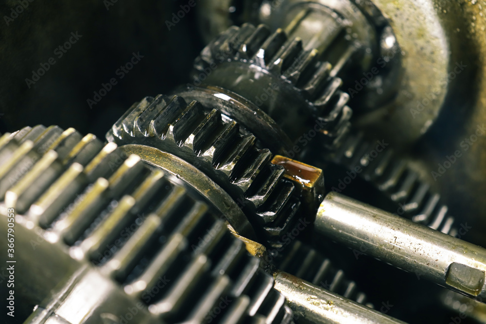 Gear mechanism of an old lathe. Moving parts of the mechanism oiled ...