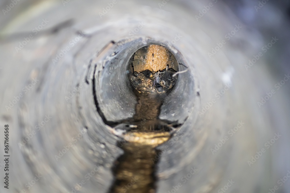 Inside a narrow concrete sewer pipe. Stock Photo | Adobe Stock