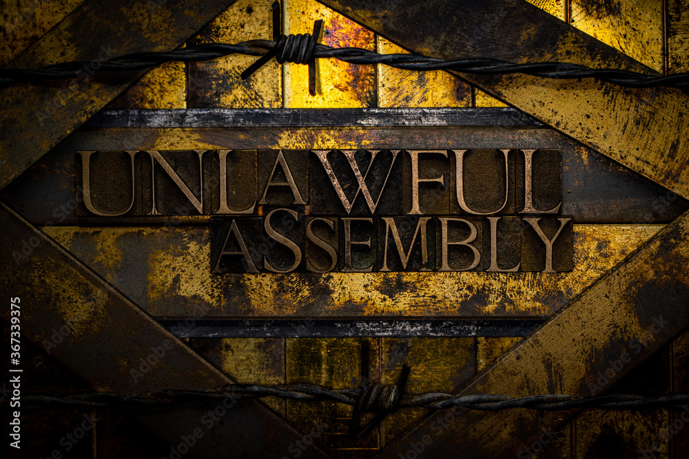 Unlawful Assembly text formed with real authentic typeset letters on ...