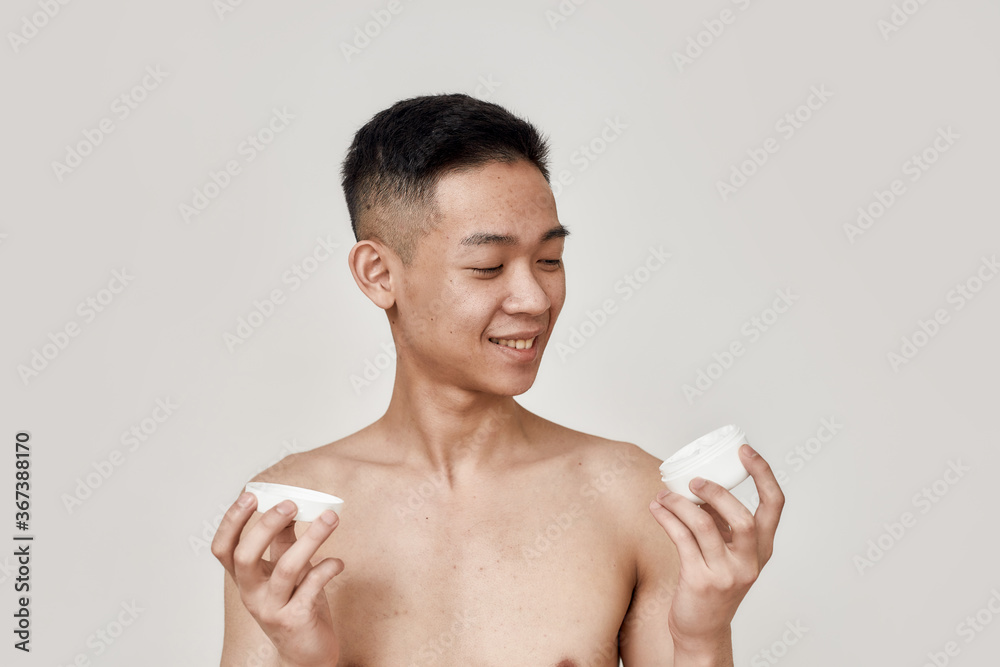 For your skin. Portrait of shirtless young asian man with clean shaven ...