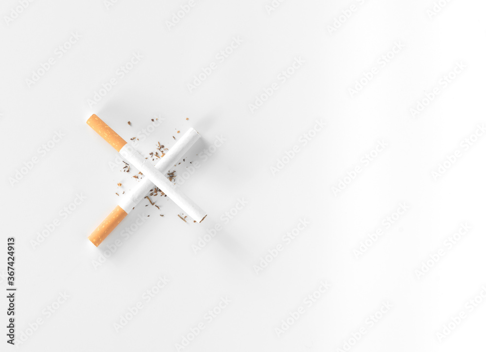 cigarettes lay as a cross sign in white background from top view with ...