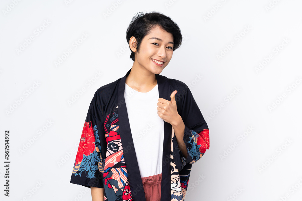 Young Vietnamese woman with short hair wearing a traditional dress over ...