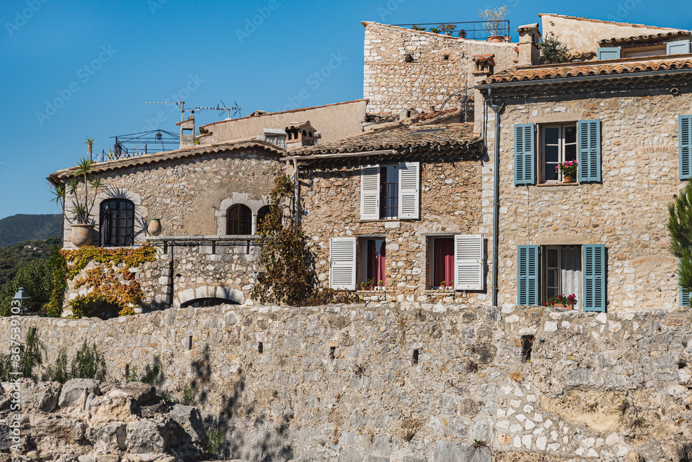 Rustic medieval village glimpse with pitched roofs and stone houses ...