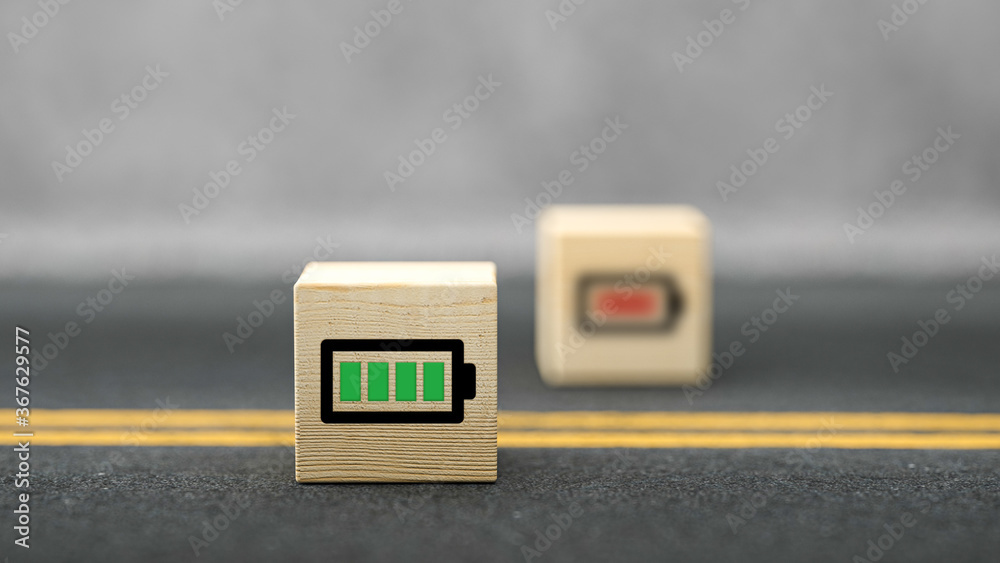 cube with full charged battery symbol and a cube out of focus with low ...