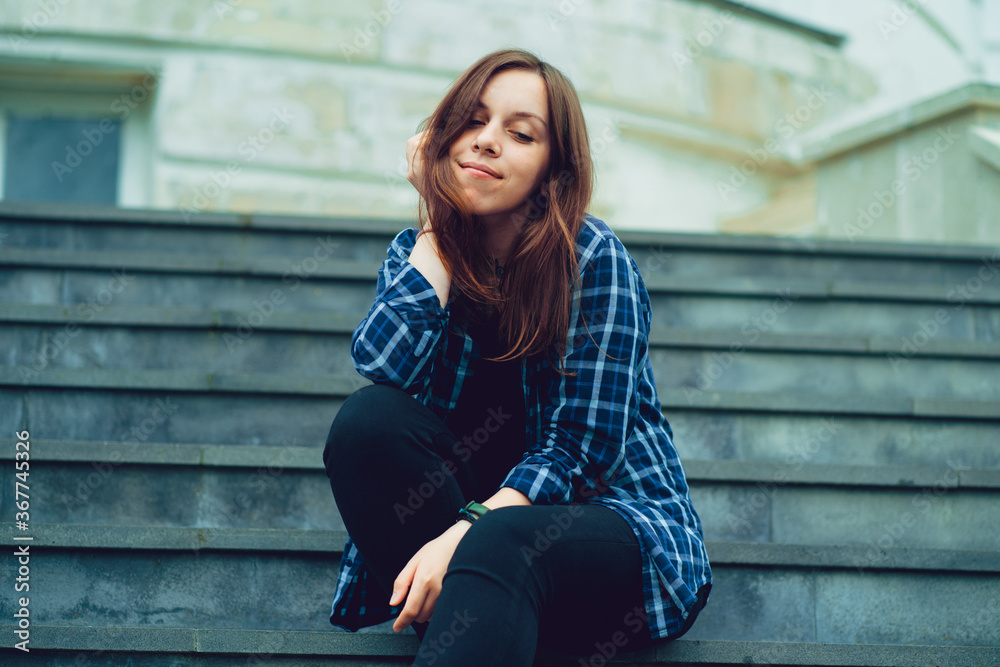 Young pretty woman poses on stairs of manor. Adult smiley female ...