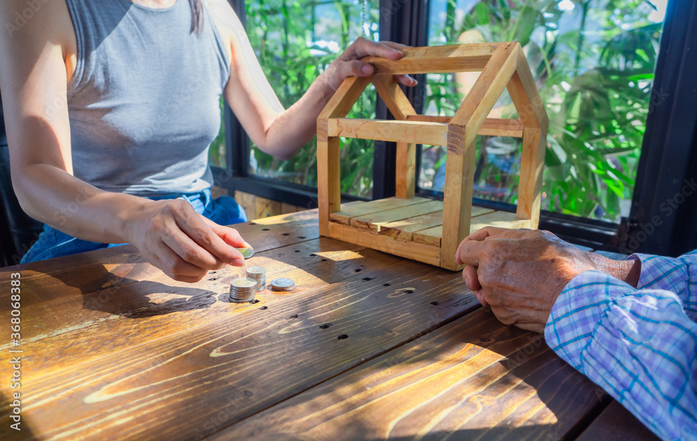 woman and senior saving money to build new house, sitting in warm ...