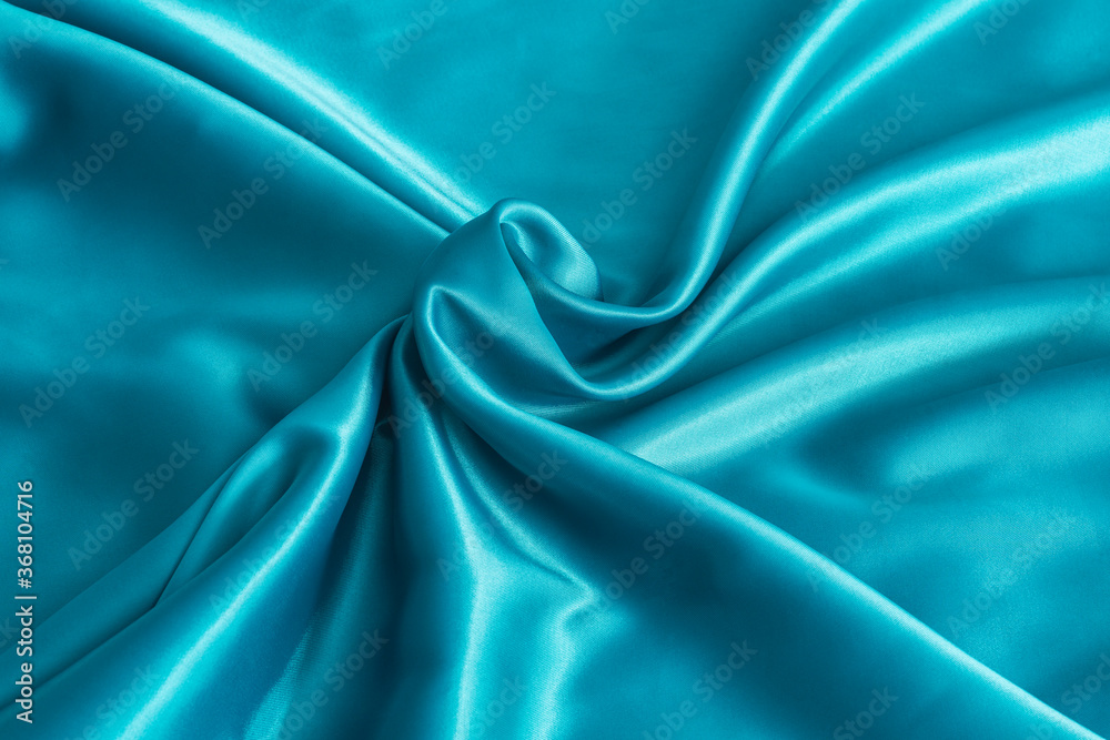 ภาพถ่าย Stock Folded aqua blue satin texture. Light blue satin fabric ...