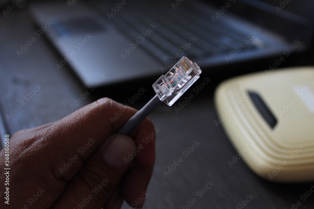 Selective focus to RJ45 Connector with crimping RJ45 tool on blurry ...