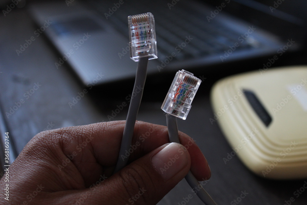 Selective focus to RJ45 Connector with crimping RJ45 tool on blurry ...