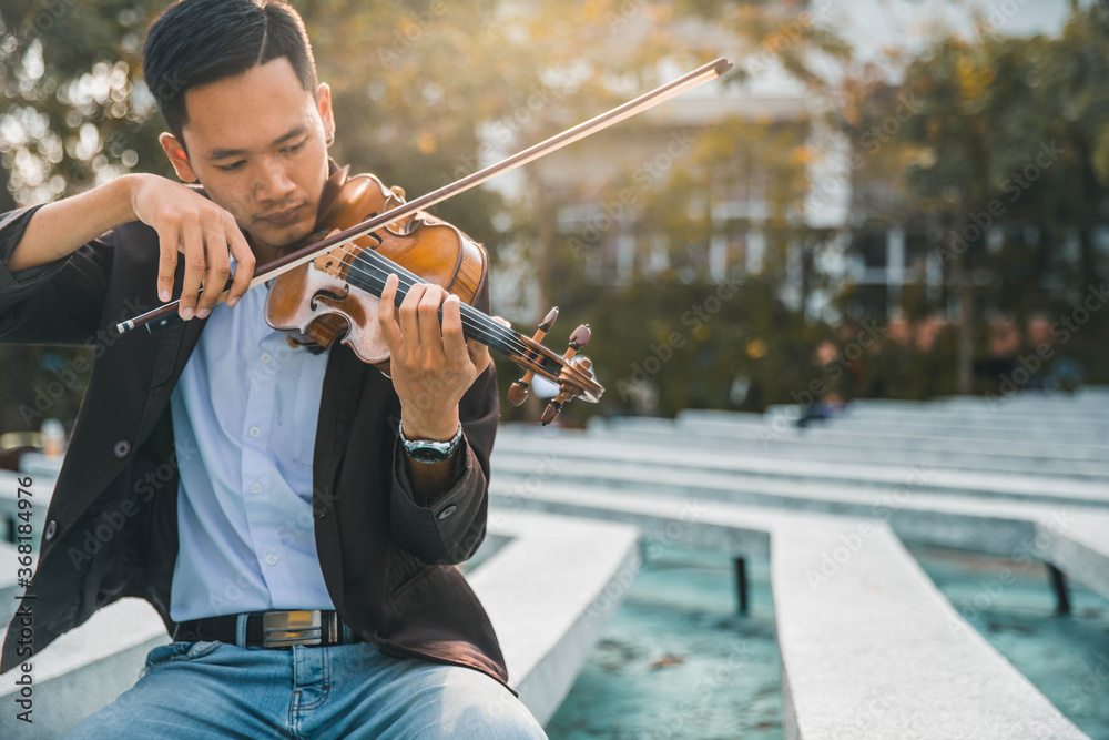 Symphony orchestra on outdoor background, hands playing violin. Male ...