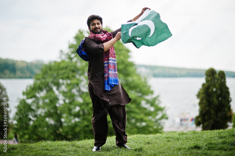 Pakistani man wear traditional clothes hold flag of Pakistan. Stock ...